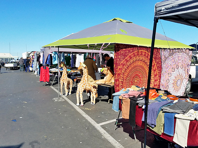 Colorful canopies create a nomadic village atmosphere where tapestries flutter like flags and giraffe statues stand guard over potential purchases.