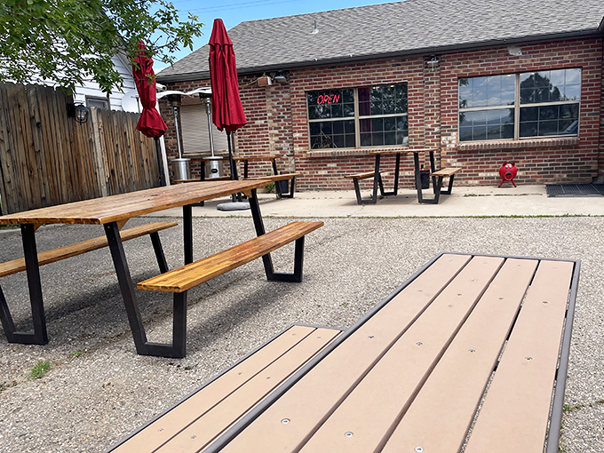 Outdoor picnic tables waiting for summer gatherings &ndash; because the only thing better than B-Man's BBQ is enjoying it under Colorado's big blue sky.