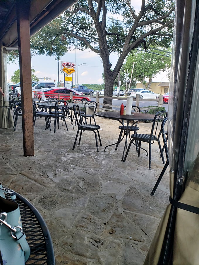 The patio where barbecue dreams come true under Texas skies. Those empty chairs are just waiting for you to claim your spot.