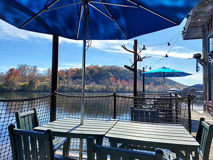 Outdoor seating that turns lunch into a lakeside event. Those blue umbrellas aren't just shade&mdash;they're the perfect frame for Ozark autumn colors.