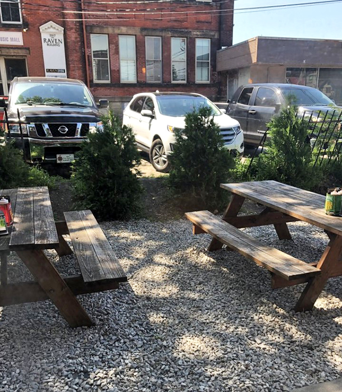 The outdoor seating area &ndash; where picnic tables and evergreens create a rustic backdrop for the serious business of barbecue appreciation.