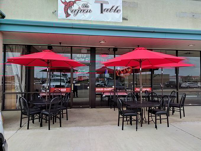 Red umbrellas shade outdoor tables where diners can enjoy their crawfish boils with a side of fresh air and people-watching.
