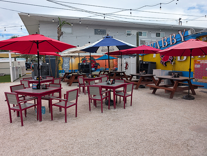 Outdoor seating that invites you to linger &ndash; red umbrellas providing shade while you contemplate ordering just one more round of those grouper bites.