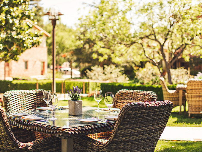 Garden dining that captures California's indoor-outdoor lifestyle &ndash; where wine glasses await filling with local vintages under dappled sunlight.