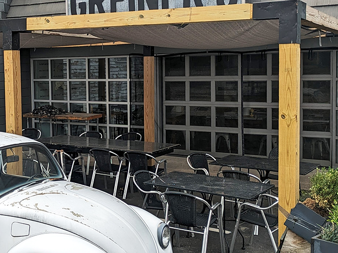 The wooden pergola creates an outdoor oasis where you can savor your sandwich while watching the world go by.