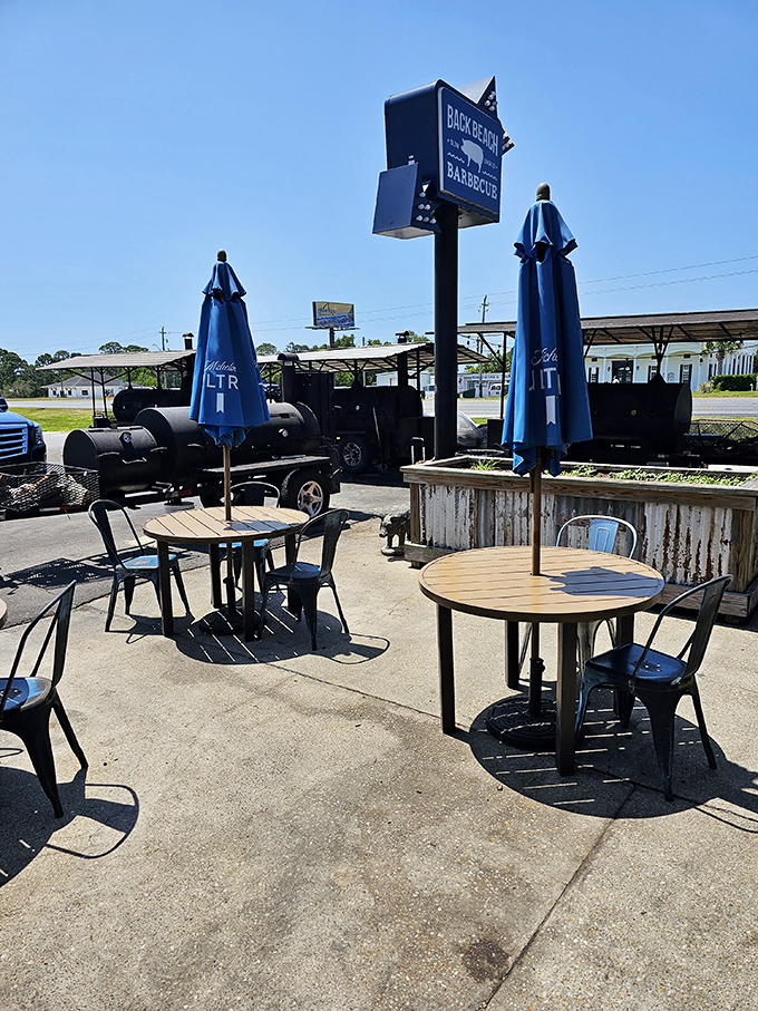 The outdoor seating area where smokers stand sentinel, a constant reminder that good things come to those who wait for properly smoked meat.