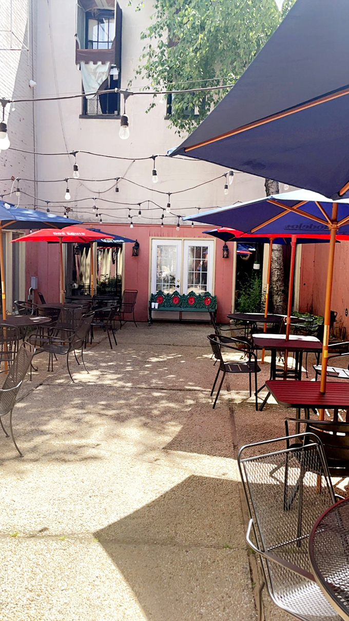 The hidden patio feels like stumbling into someone's secret garden party. String lights overhead promise to make everything look better after your second margarita.