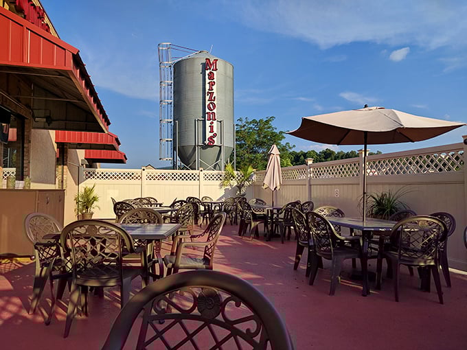 The outdoor patio where summer evenings stretch into memory-making nights, with that brewing tank standing sentinel over good times.