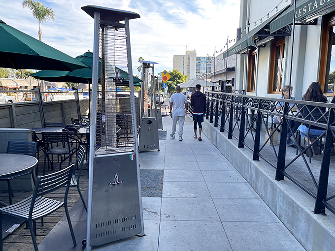 The outdoor patio – where ocean breezes enhance every bite. San Diego's perfect weather practically demands al fresco dining of this caliber.