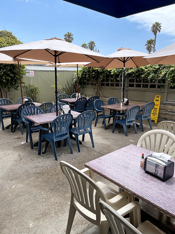 The outdoor seating area offers a peaceful retreat under canvas umbrellas. California dining as it should be&mdash;casual, breezy, and sun-kissed.