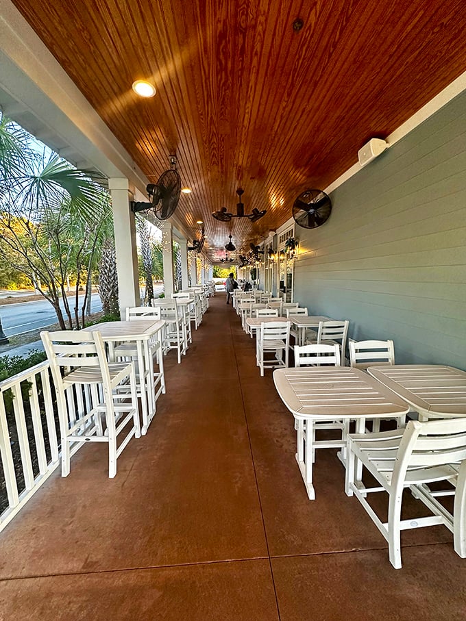 The outdoor seating area offers al fresco dining with a side of Southern charm&mdash;wooden ceiling, ceiling fans, and white rocking chairs that practically demand you slow down.
