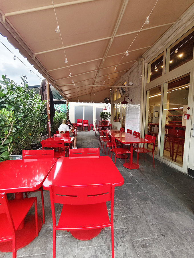 String lights, red tables, and fresh air&mdash;the patio setting that elevates your burger experience from meal to memory.