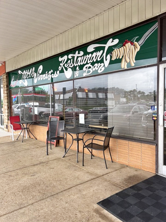 Outdoor seating with that classic "pasta twirl" sign &ndash; a sidewalk beacon for those who appreciate proper carbohydrate worship.