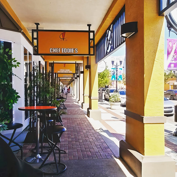 The covered walkway outside Chef Eddie's offers shade and anticipation&mdash;the yellow columns standing like sentinels guarding culinary treasures within.