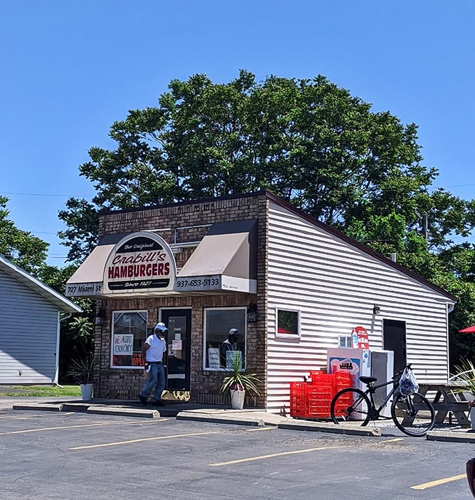 Morning sunshine bathes the humble burger shrine, while a parked bicycle suggests the lengths some will travel for slider satisfaction.