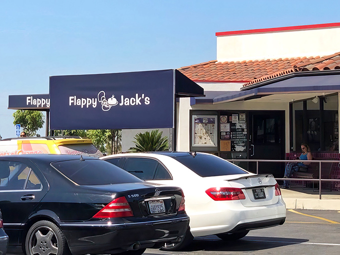 The blue awning beckons like a breakfast lighthouse. Flappy Jack's exterior might be modest, but those full parking spaces tell the real story of what awaits inside.