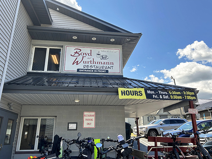Morning light catches the sign announcing hours that start before most of us hit snooze. Early birds get more than worms here&mdash;they get homemade breakfast.