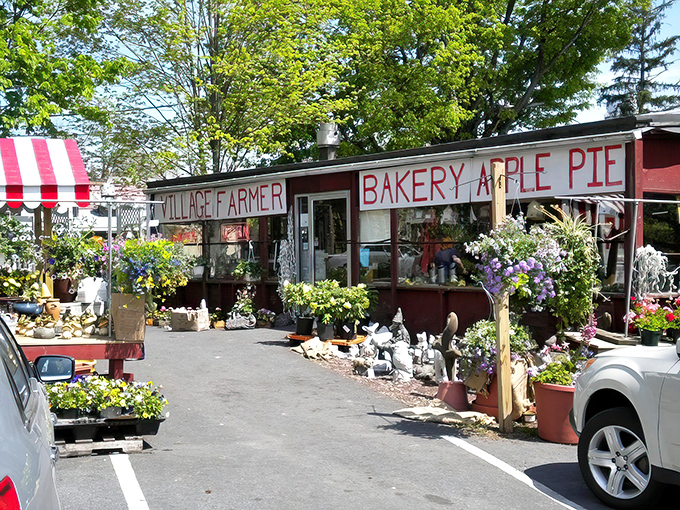 Spring blooms frame the rustic charm of this roadside gem. The "BAKERY APPLE PIE" sign isn't just advertising&mdash;it's a promise of deliciousness within.