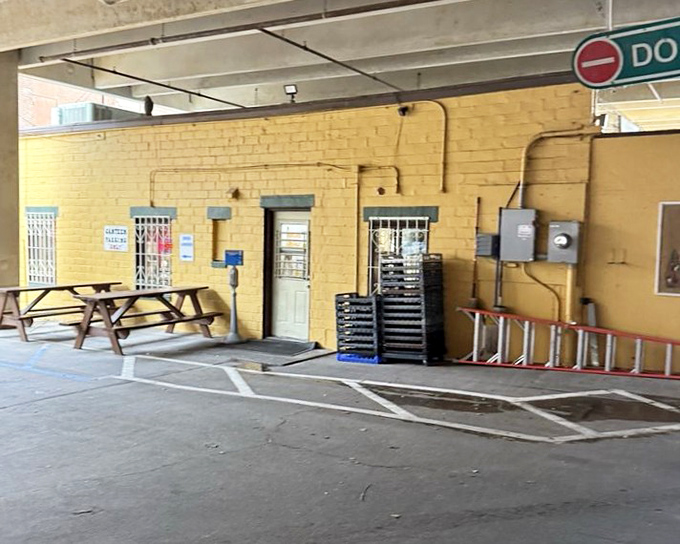 The unassuming exterior with picnic tables nearby, inviting you to sit and contemplate the beautiful simplicity of excellent sandwiches.