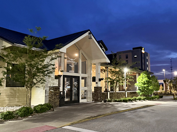 Evening lighting transforms the exterior into an inviting beacon for hungry diners seeking their next great steak experience.