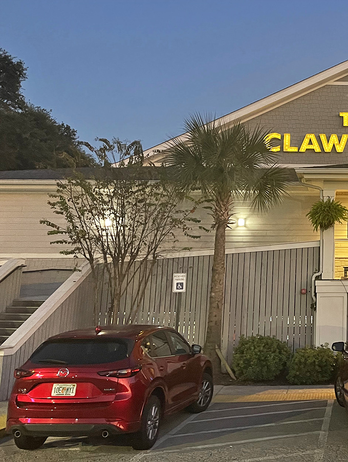 Even at dusk, The Claw House glows with invitation, palm trees standing sentinel over your seafood pilgrimage.