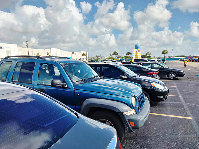 The parking lot stretches toward the horizon, cars baking under the Florida sun. That blue dome beacon in the distance promises air conditioning and amazing finds.