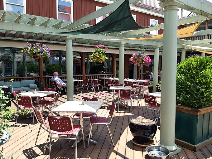 The outdoor patio, adorned with colorful hanging baskets, offers al fresco dining that makes Virginia summers feel like a Mediterranean holiday.