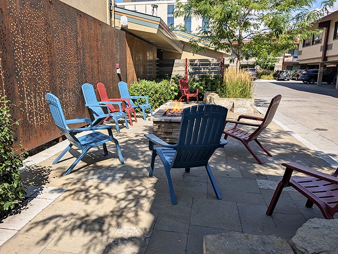 Colorful Adirondack chairs create an impromptu community space where strangers become friends over shared pastry recommendations.