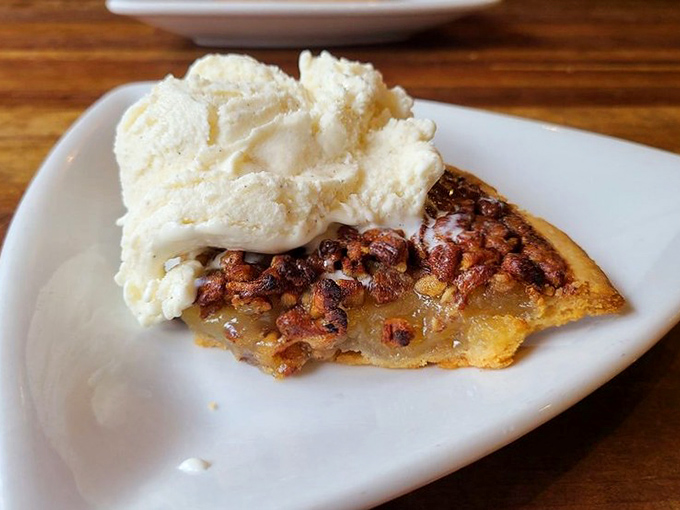 Pecan pie that makes you understand why people write songs about Southern desserts, topped with ice cream that's melting just right.