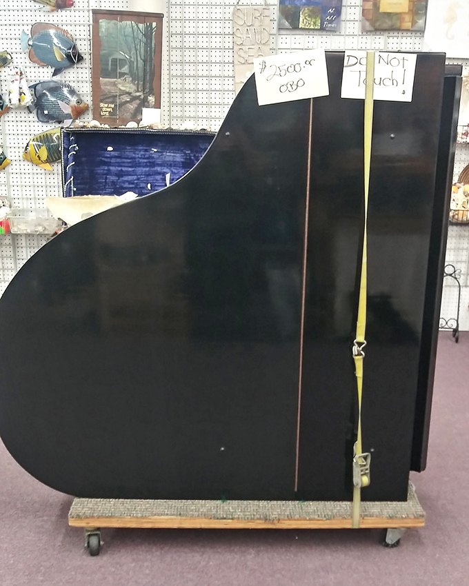 "Do Not Touch" warns the sign on this ebony grand piano. Some treasures command respect even in their retirement years.