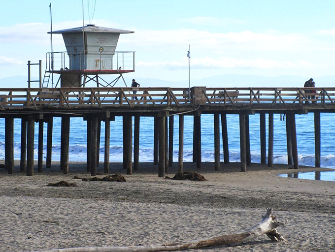 The fishing pier stretches toward the horizon, where patient anglers cast their lines and their cares into the deep blue Pacific.