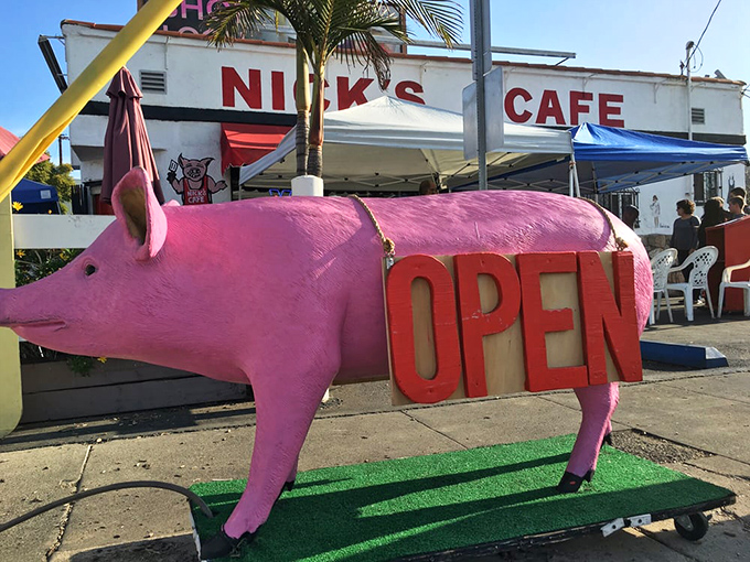 The pink pig statue stands guard outside—a whimsical sentinel announcing "good eats ahead" to hungry passersby.
