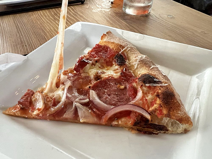 The perfect slice pulls away with that Instagram-worthy cheese stretch that makes everyone at neighboring tables suddenly crave what you're having.