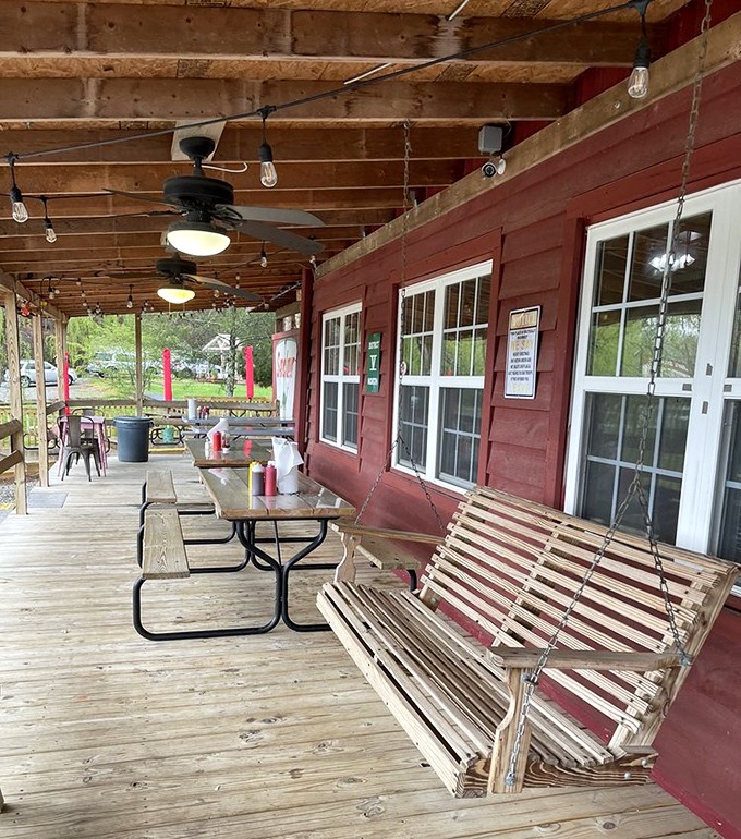 The porch swing gently sways, inviting you to sit a spell. It's the perfect spot for post-barbecue contemplation and meat sweats.