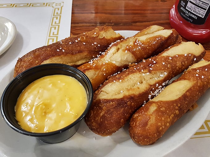 Pretzel sticks that somehow manage to be both crispy and chewy, served with a cheese sauce so good you'll consider drinking it when no one's looking.