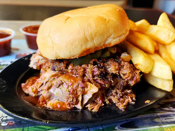 The pulled pork sandwich doesn't just sit on the plate&mdash;it commands it, with meat so tender it surrendered to smoke hours ago, flanked by golden fries. 