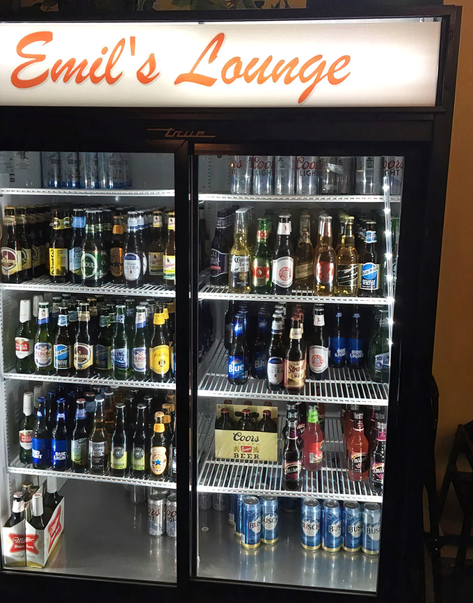 The beer fridge&mdash;a cold, glowing beacon of hope for thirsty diners. A democratic display where craft brews and old standbys coexist peacefully.