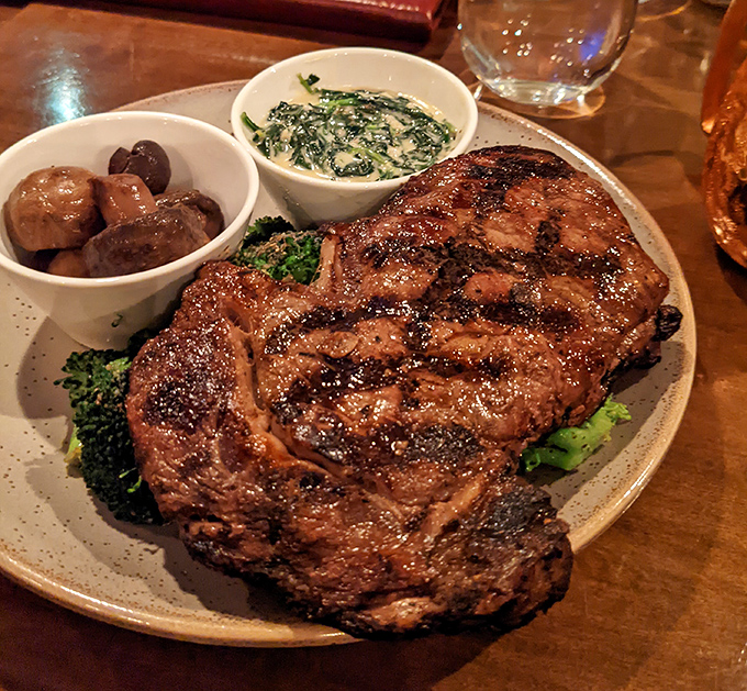 A ribeye steak with such perfect grill marks it could teach geometry, accompanied by sides that know their supporting role perfectly.