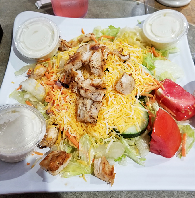 A salad that doesn't apologize for being hearty. Those grilled chicken strips aren't hiding in the greens &ndash; they're proudly standing their ground.