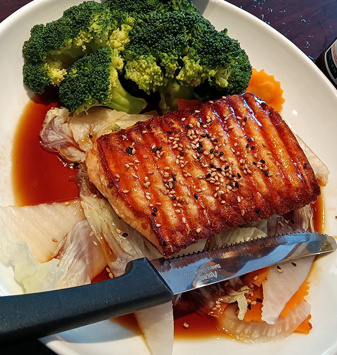Salmon teriyaki with perfect grill marks that would make a backyard BBQ champion weep with envy, glazed to glossy perfection.