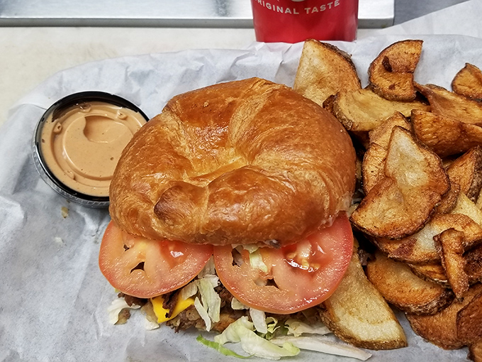 A sandwich that proves sometimes the best things in life come on a croissant, surrounded by house-made chips that shatter with each bite.