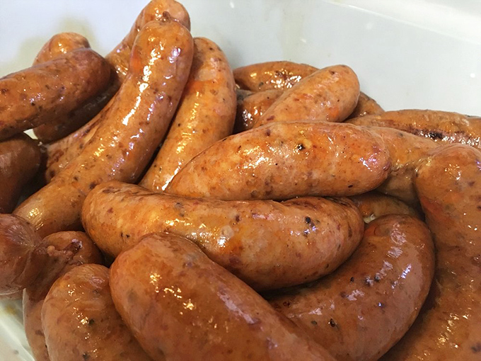 Sausages glistening with promise, ready to snap between your teeth and remind you why simple pleasures are often the most profound.