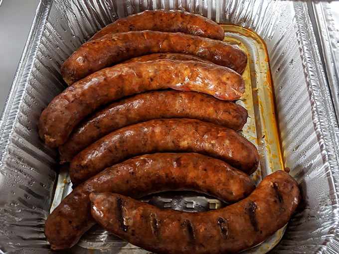 Sausages glistening with smoky promise&mdash;each link a testament to the art of proper BBQ technique.