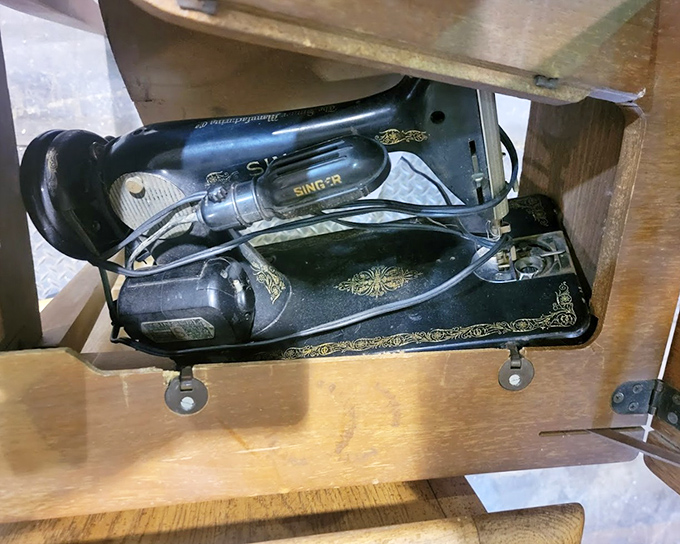 Hidden beneath this unassuming wooden cabinet: a vintage Singer sewing machine, ready to stitch together past craftsmanship with future creativity.