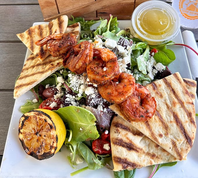 Grilled shrimp perched on greens with grilled pita proves that lighter fare here receives the same loving attention as their famous wings.