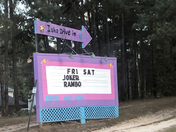 The iconic purple marquee points the way to cinematic magic, announcing weekend double features beneath Mississippi stars.