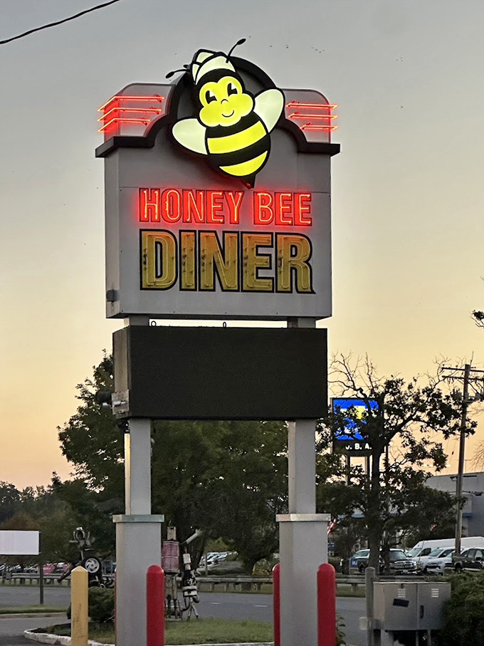 The roadside sign stands tall against the sunset, a beacon of hope for travelers seeking authentic diner delights.