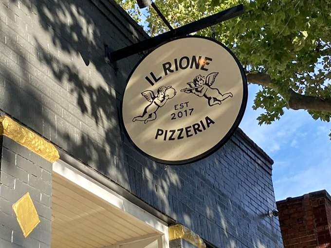 That sign isn't just marking a restaurant; it's a beacon for pizza pilgrims who understand that sometimes the best food comes without unnecessary flash.