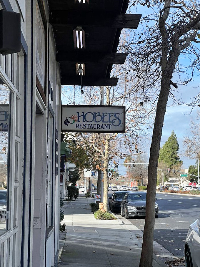 The simple hanging sign marks the spot where breakfast pilgrims find their holy grail &ndash; proving the best culinary destinations don't need neon to shine.