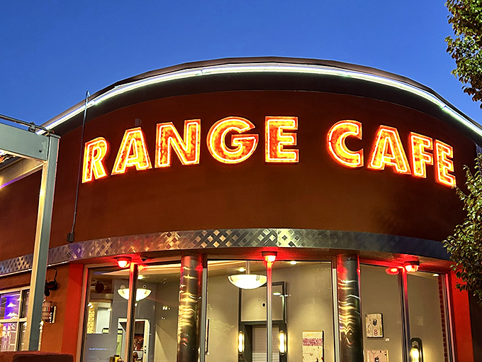 The neon sign glows like a promise in the evening sky. Some restaurants have signs; Range Cafe has a beacon calling you home.